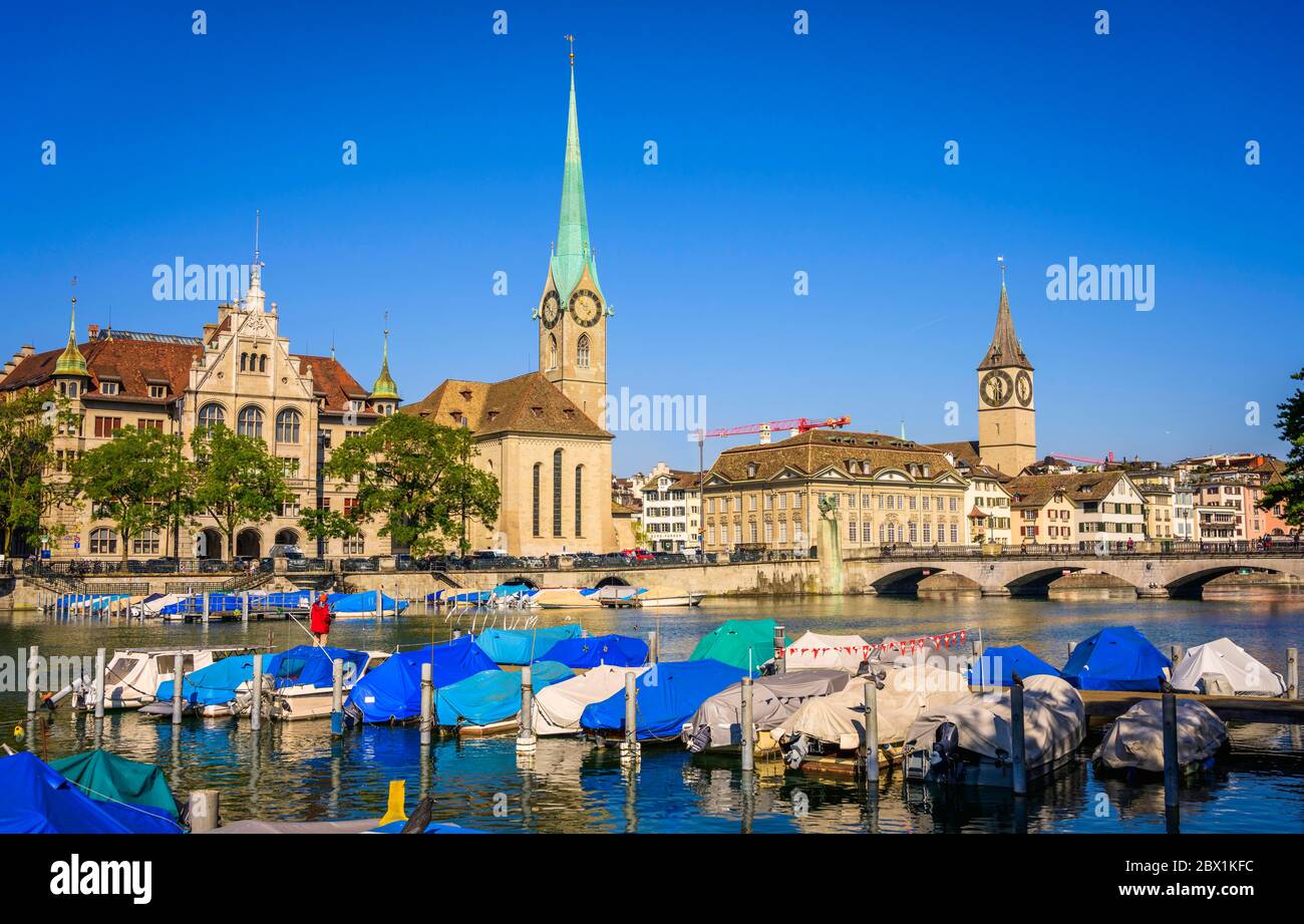 Boats on the river Limmat, church Fraumuenster, Muensterbruecke, Zurich ...
