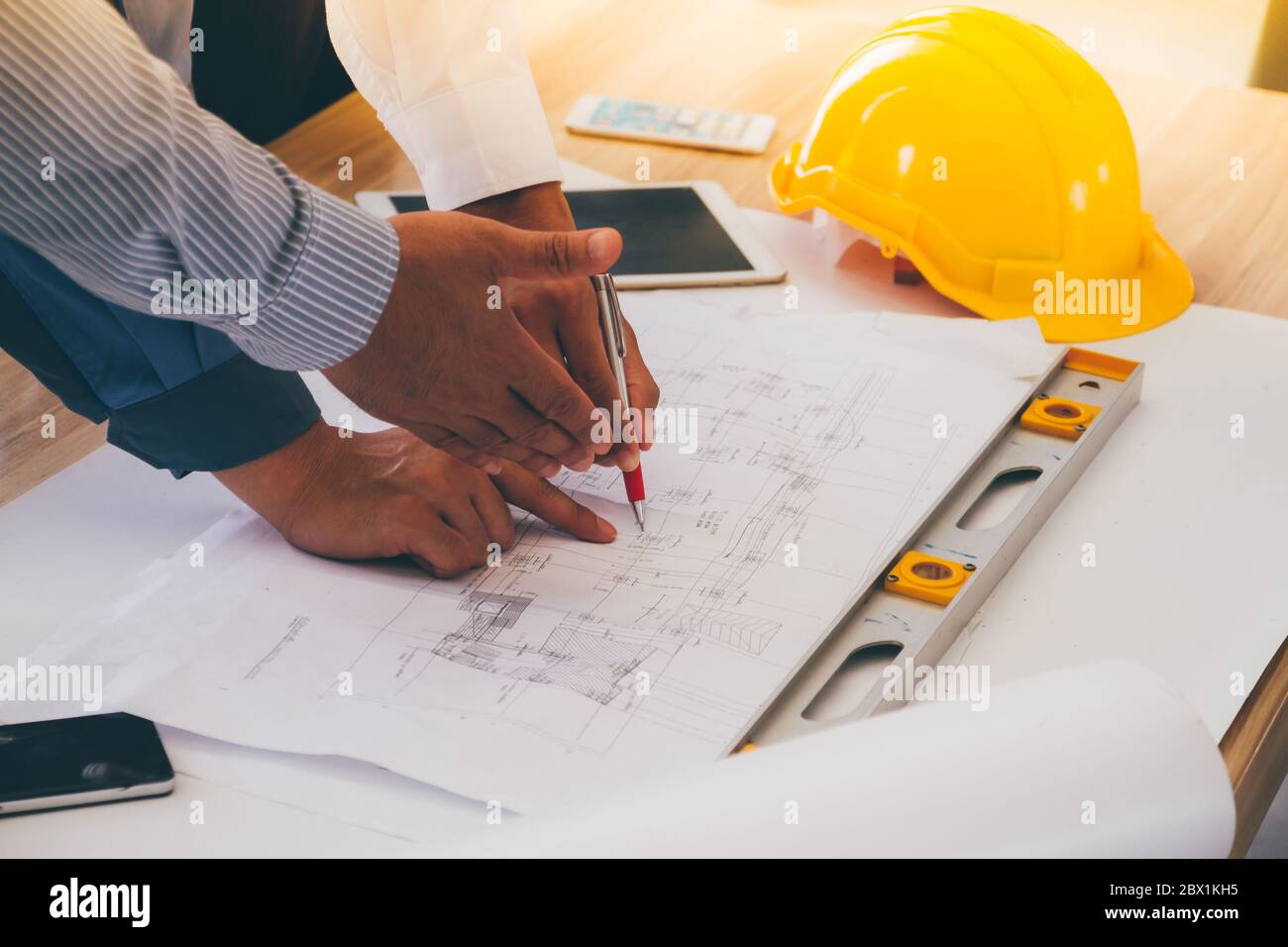 Team of engineers discussing architecture plan sketch at the ...