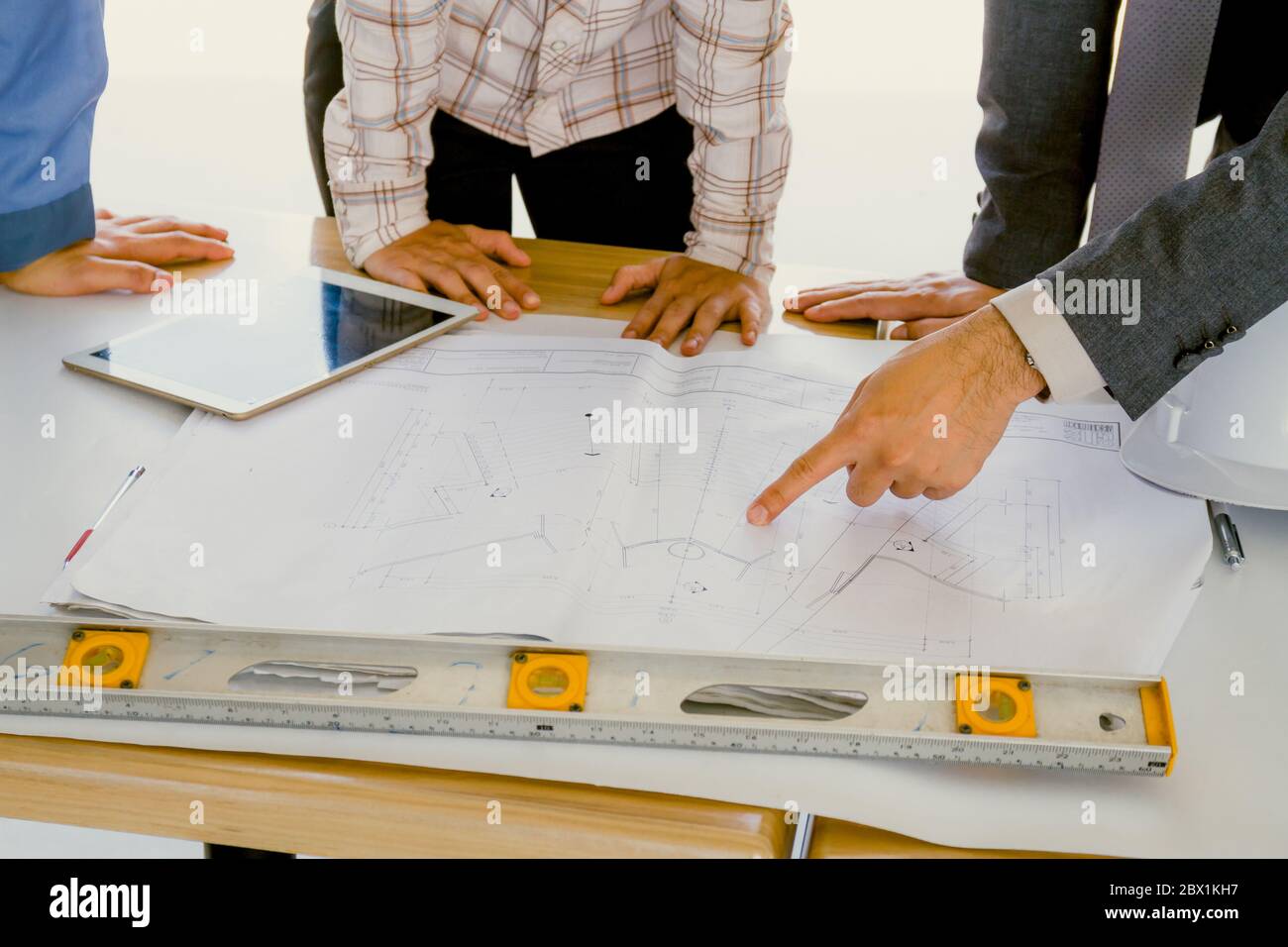 Team of engineers discussing architecture plan sketch at the ...