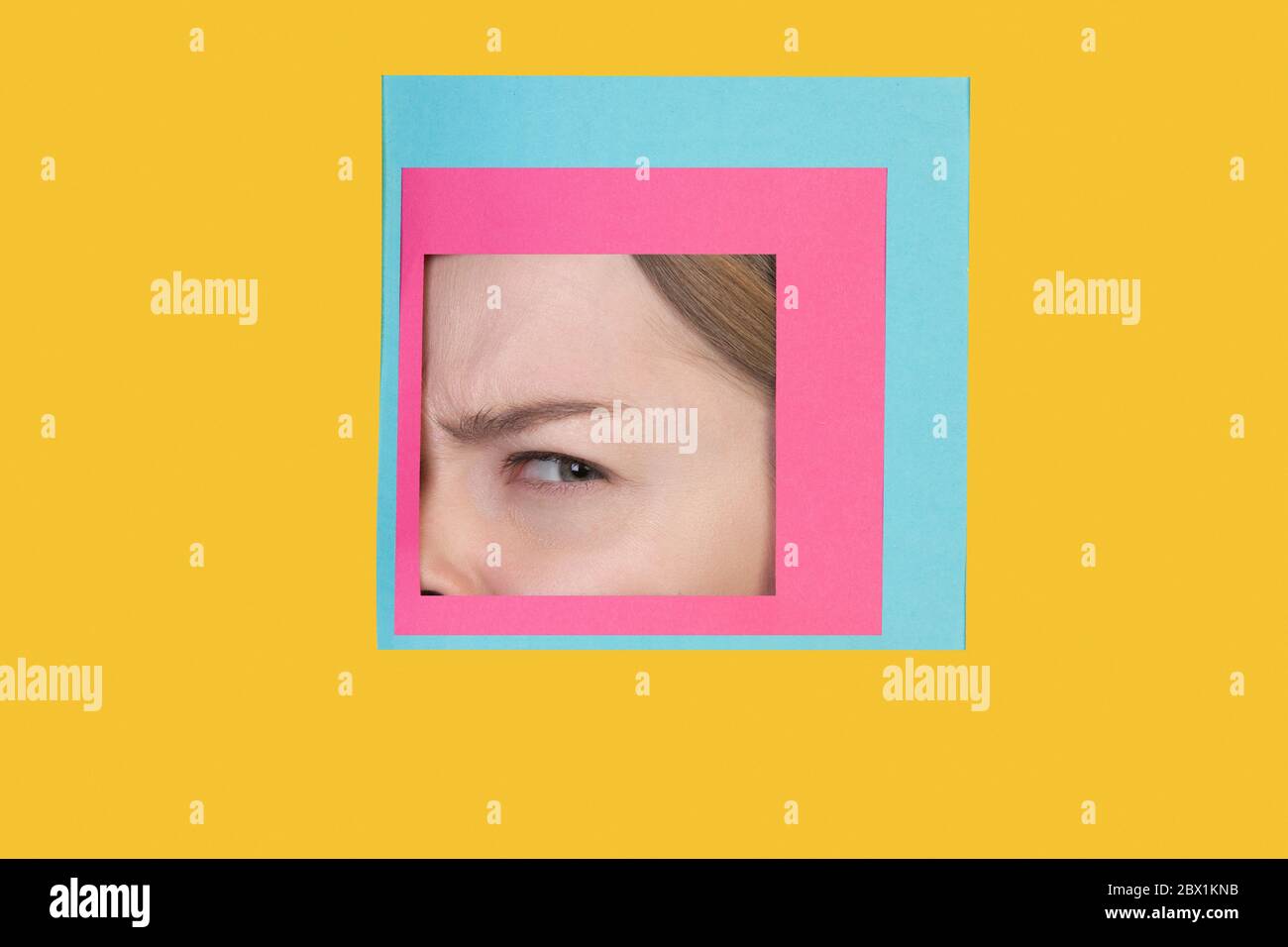 Doubt. Face of emotional caucasian woman peeks throught square in ...