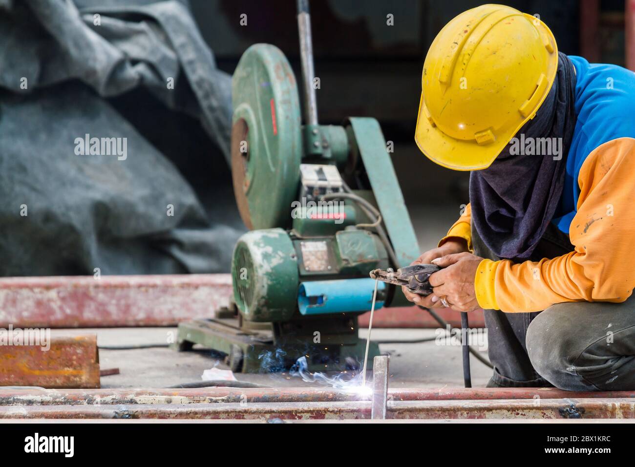 Steel Workers welding, grinding, cutting in metal industry Stock Photo ...
