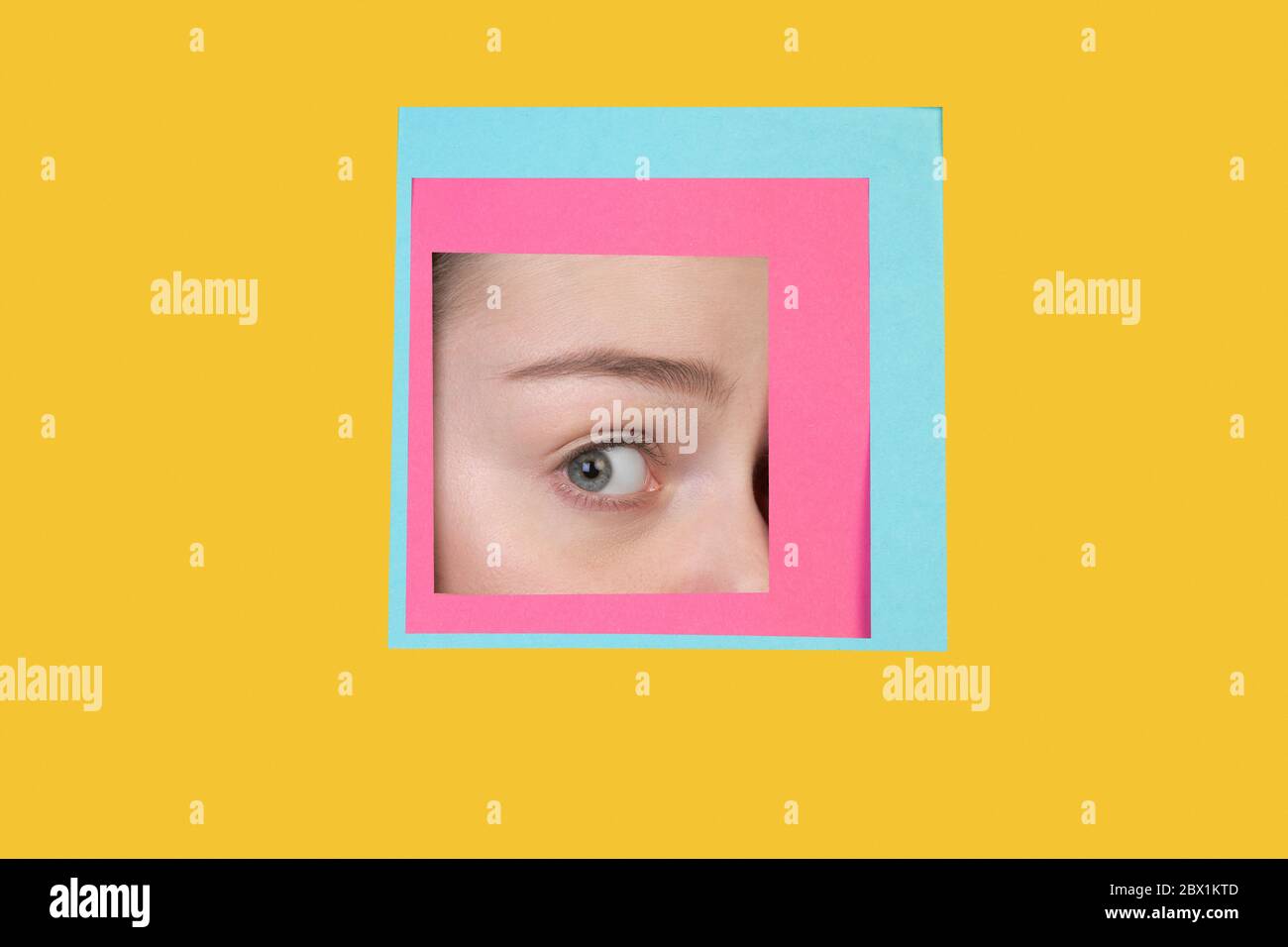 Shocked. Face of emotional caucasian woman peeks throught square in ...