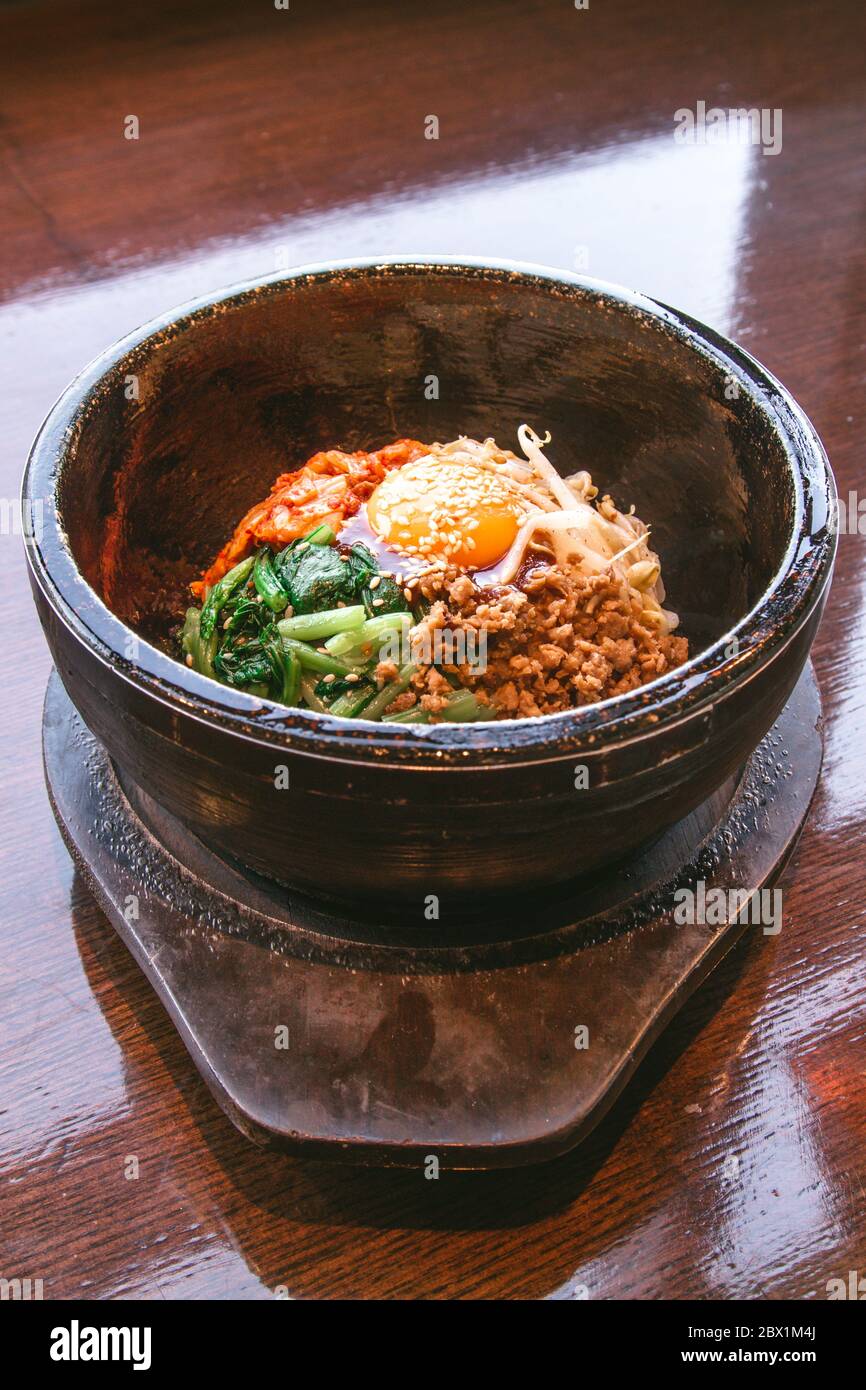 Bibimbap in a heated stone bowl, Korean food Stock Photo - Alamy