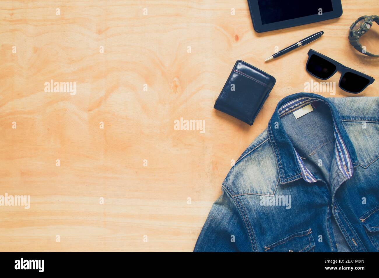 Top view of clothing and diverse personal accessory on the wooden table ...