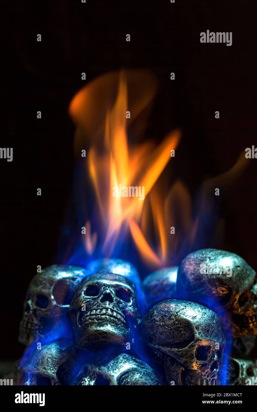 Burning skulls on black background Stock Photo - Alamy
