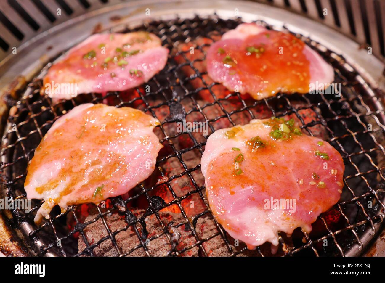 Pork grill on hot coals. This kind of food is a Korean or Japanese BBQ ...