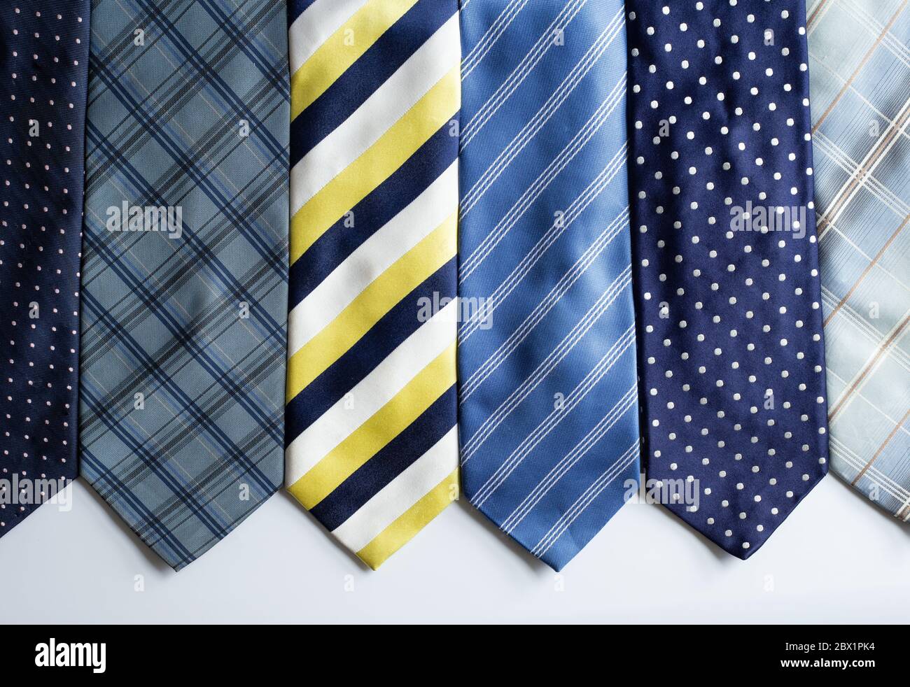 Many different colorful ties, on white background Stock Photo - Alamy