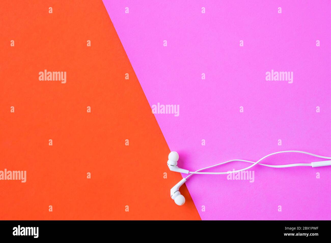 Earphones on colorful background. Free space for text Stock Photo - Alamy