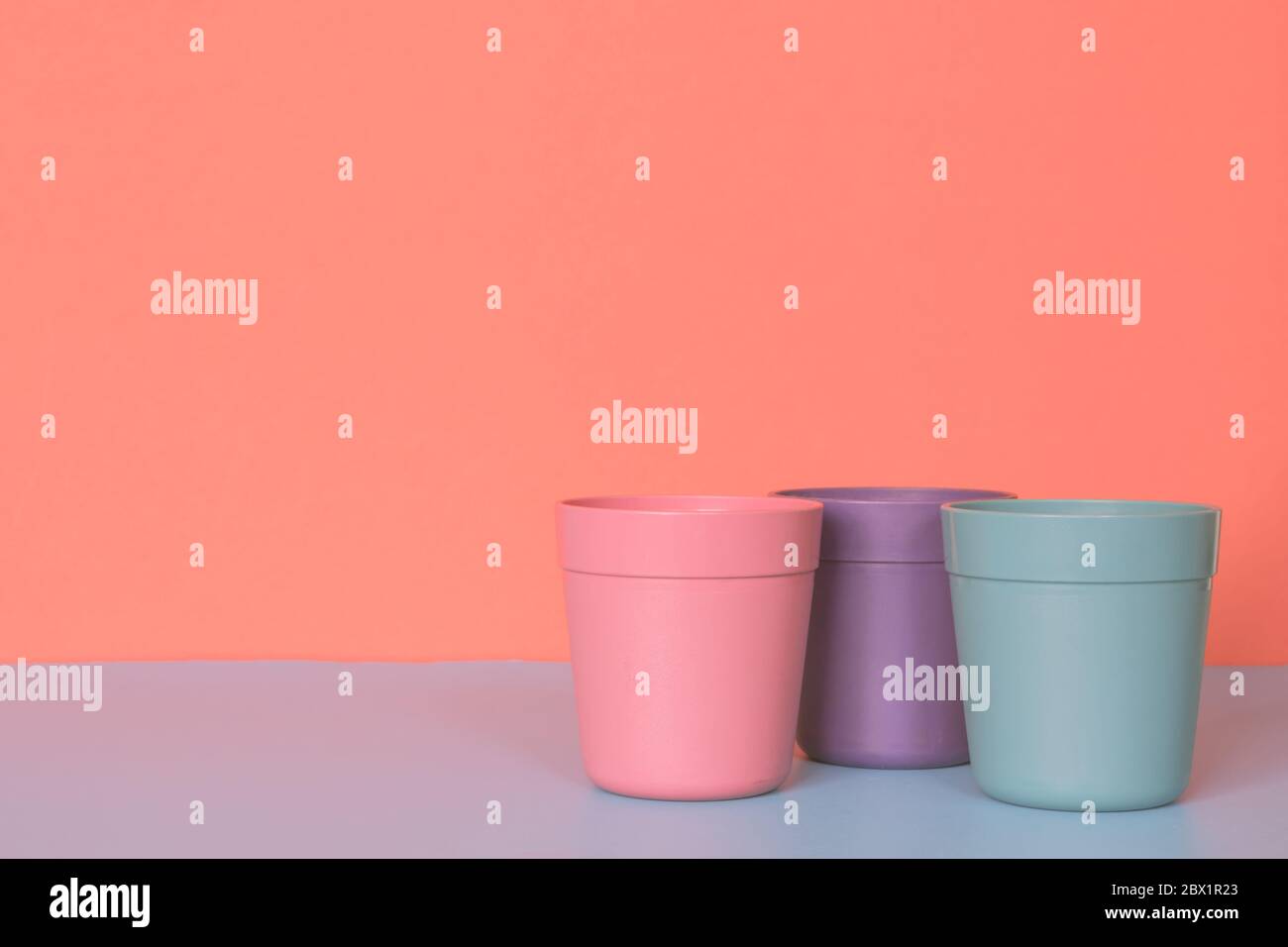Three color plastic cup on pastel colors background Stock Photo - Alamy