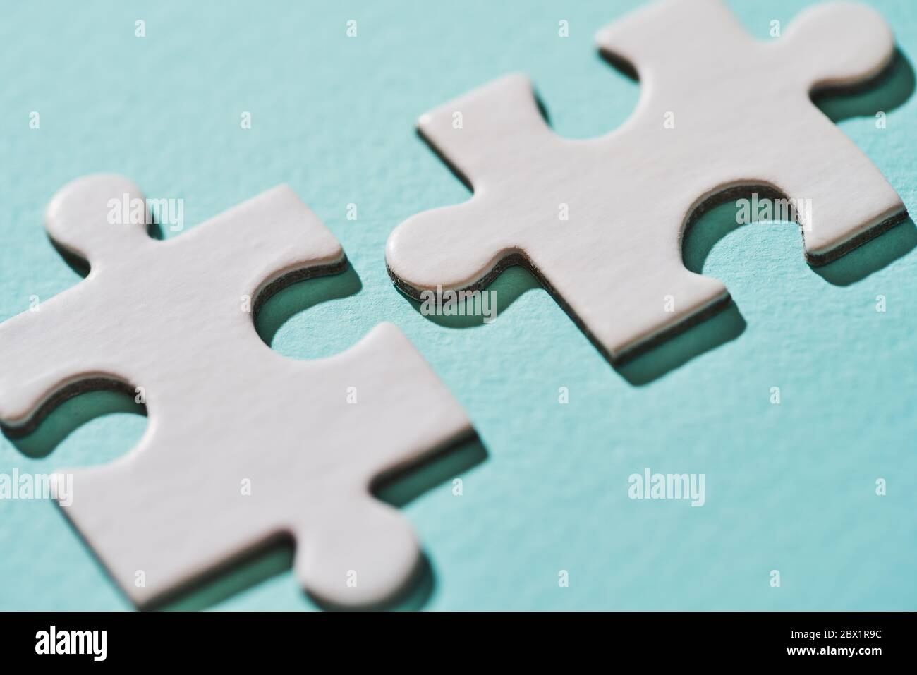 Two connecting puzzle piece. Concept of connection Stock Photo - Alamy