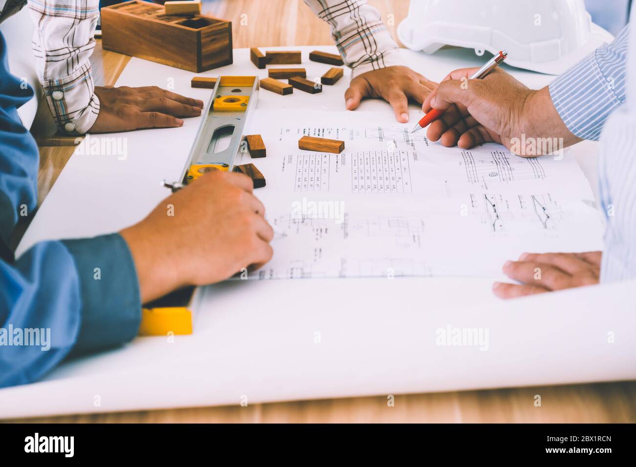 Team of engineers discussing architecture plan sketch at the ...