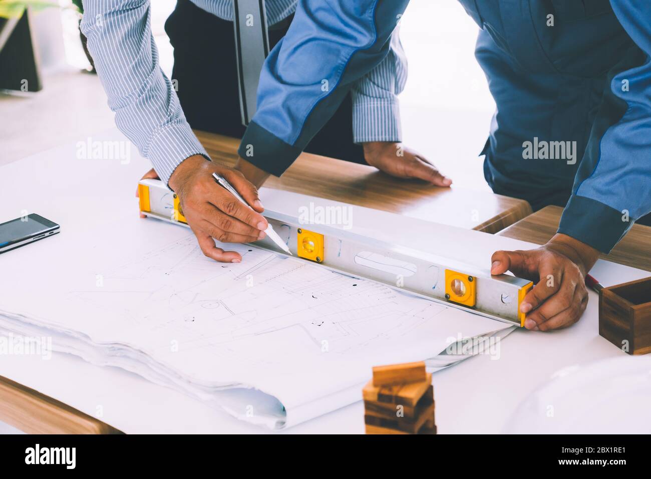 Team of engineers discussing architecture plan sketch at the ...