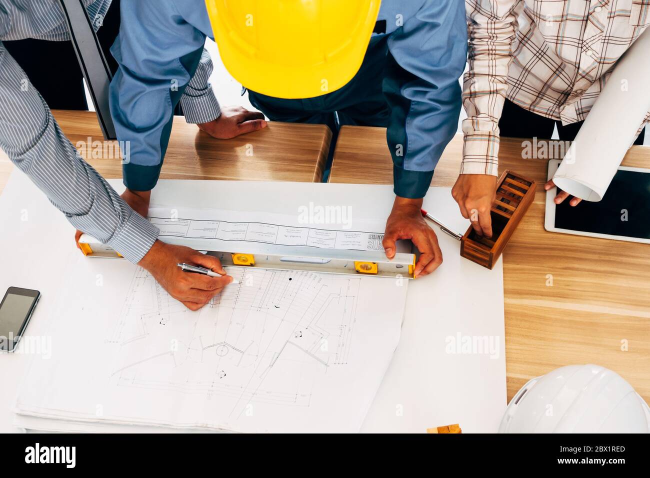 Team of engineers discussing architecture plan sketch at the ...