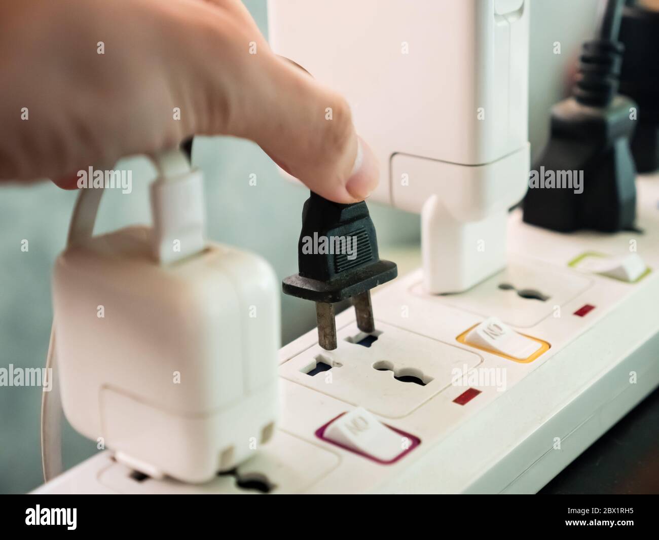 Hand holding electric plug, Multiple socket with connected plugs Stock ...