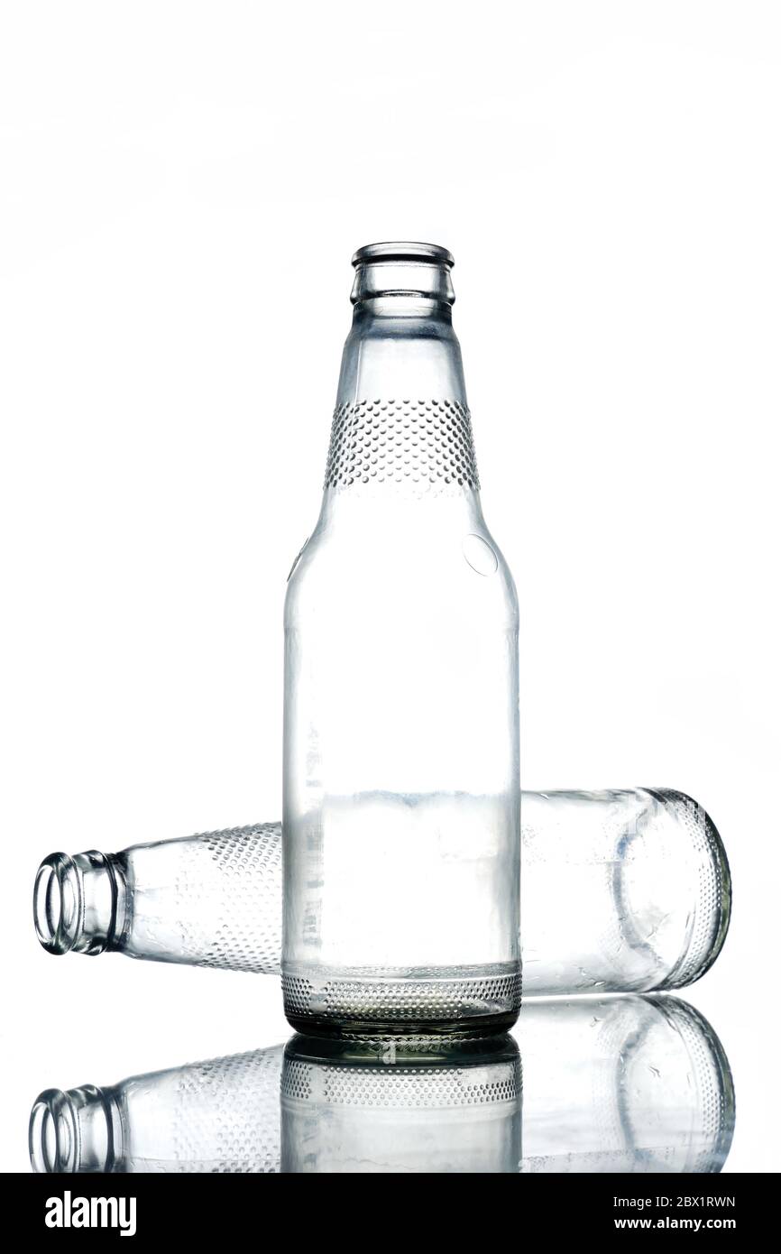 Empty colorless glass bottles on a white background Stock Photo - Alamy