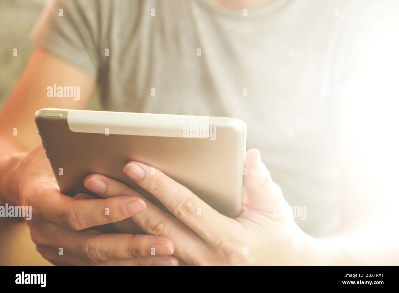 Close up of male hands using tablet, Flare from the sunlight Stock ...