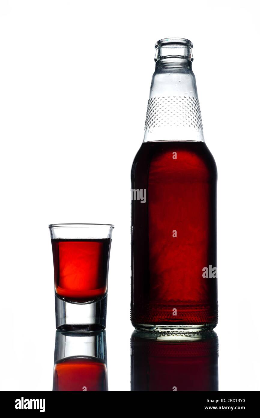 Bottle of alcohol with shot on a white background Stock Photo - Alamy