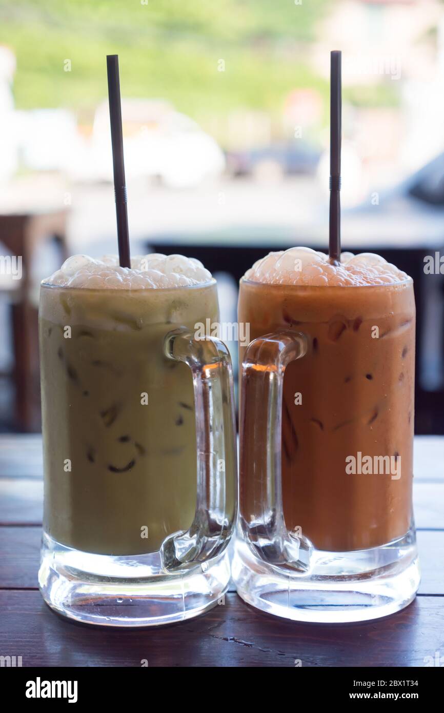 Milk green tea and milk thai tea in glass mugs on wood table Stock ...