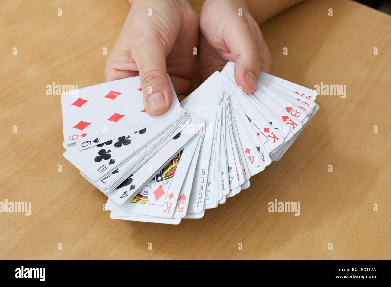 Hands hold a deck of playing cards Stock Photo - Alamy