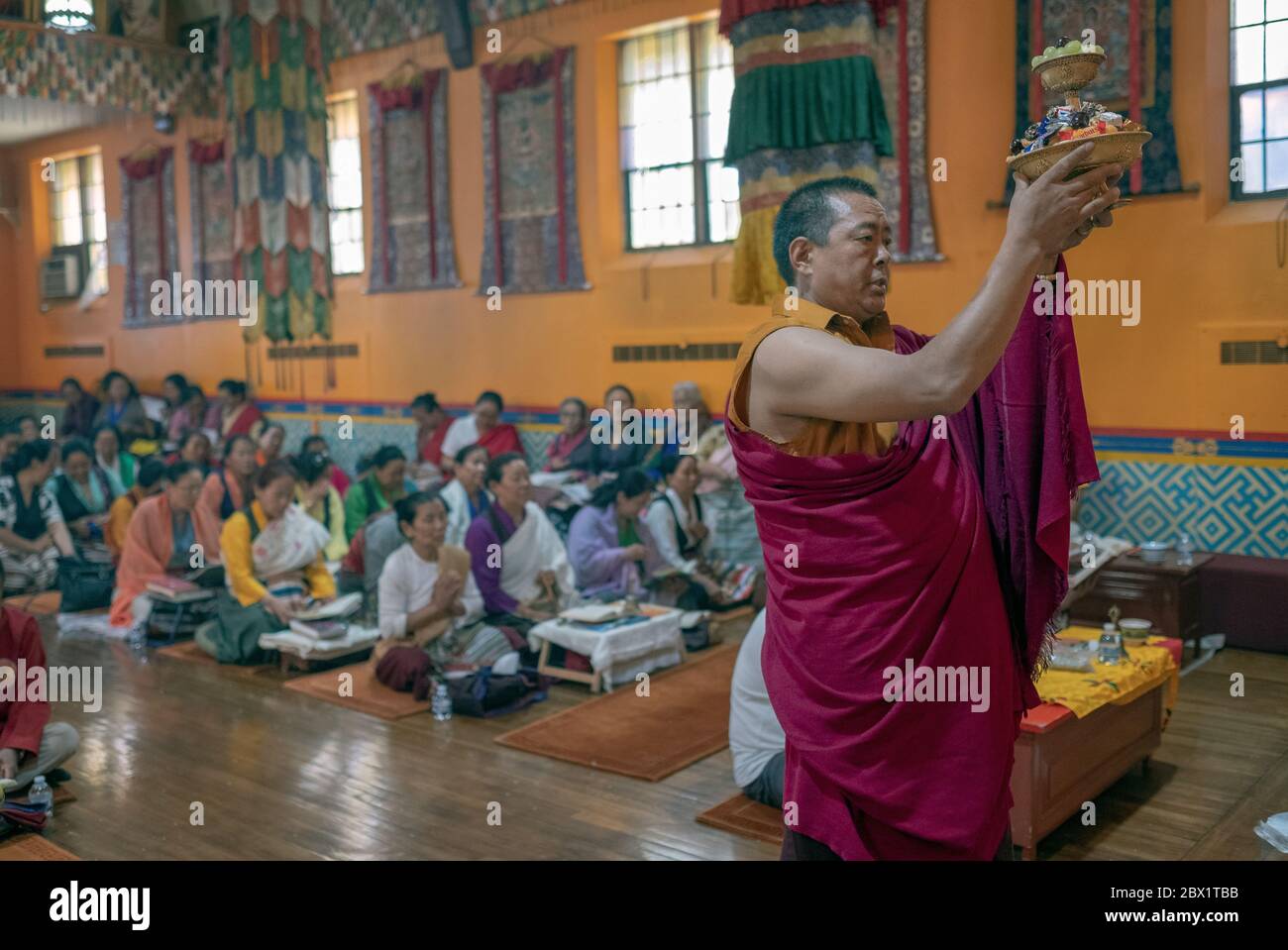A Buddhist monk makes food offerings to Buddah at a Sherpa temple in ...