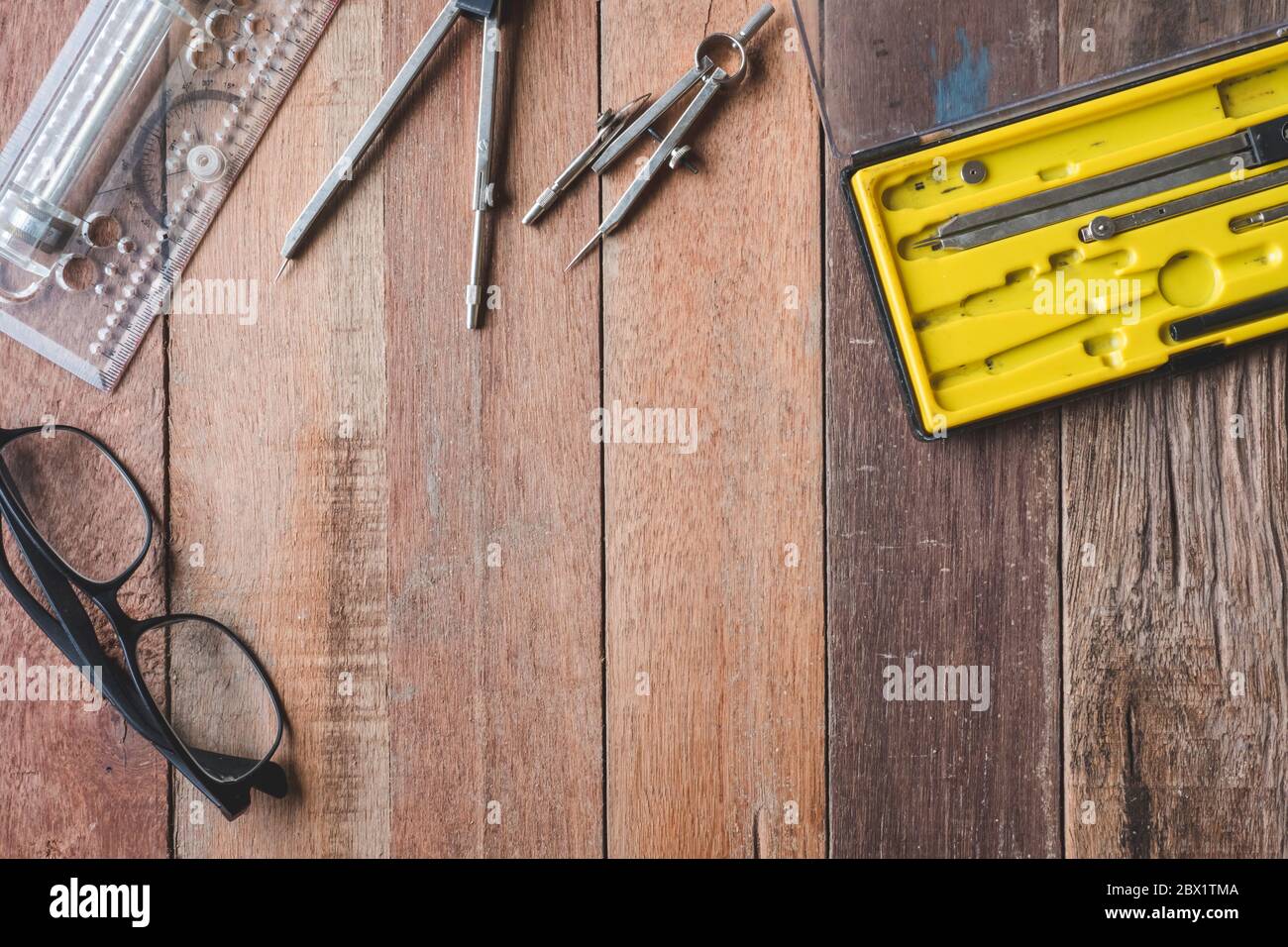 Top view of engineering tools with glasses on wooden table background ...