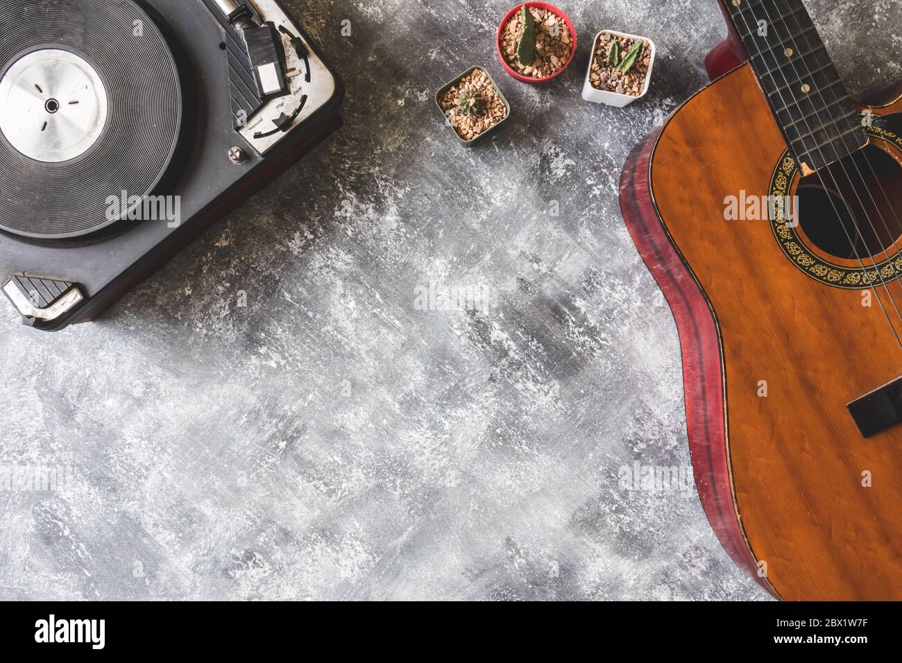 Top view of Vintage Turntable with Guitar and cactus on grunge ...