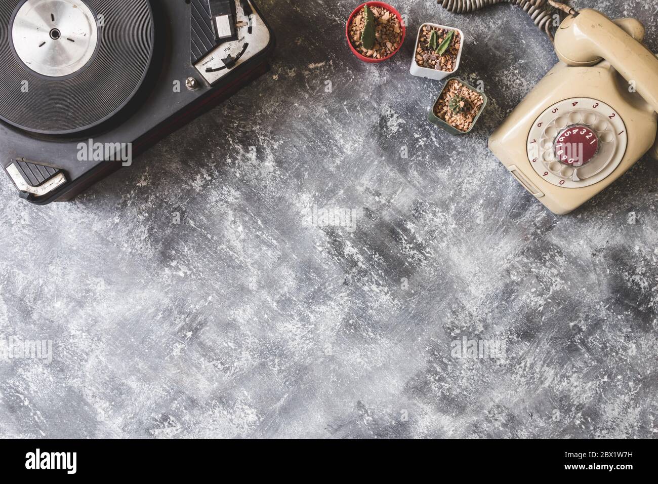 Top view of Vintage Turntable with old telephone and cactus on grunge ...