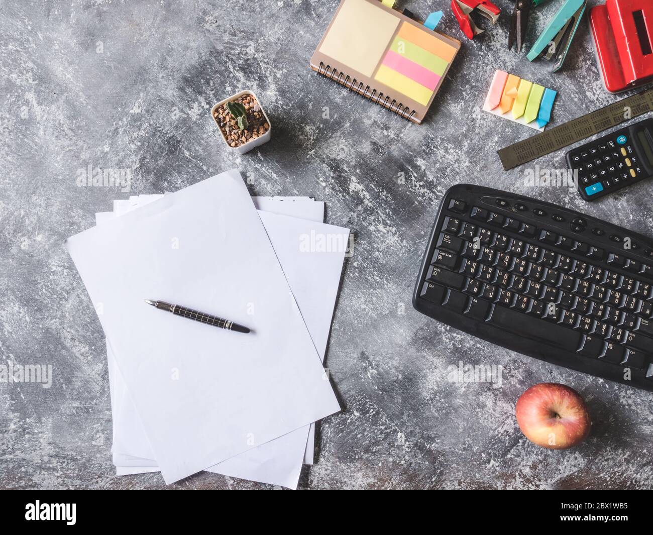 Top view of Paper sheet with Office supplies on Grunge gray background ...