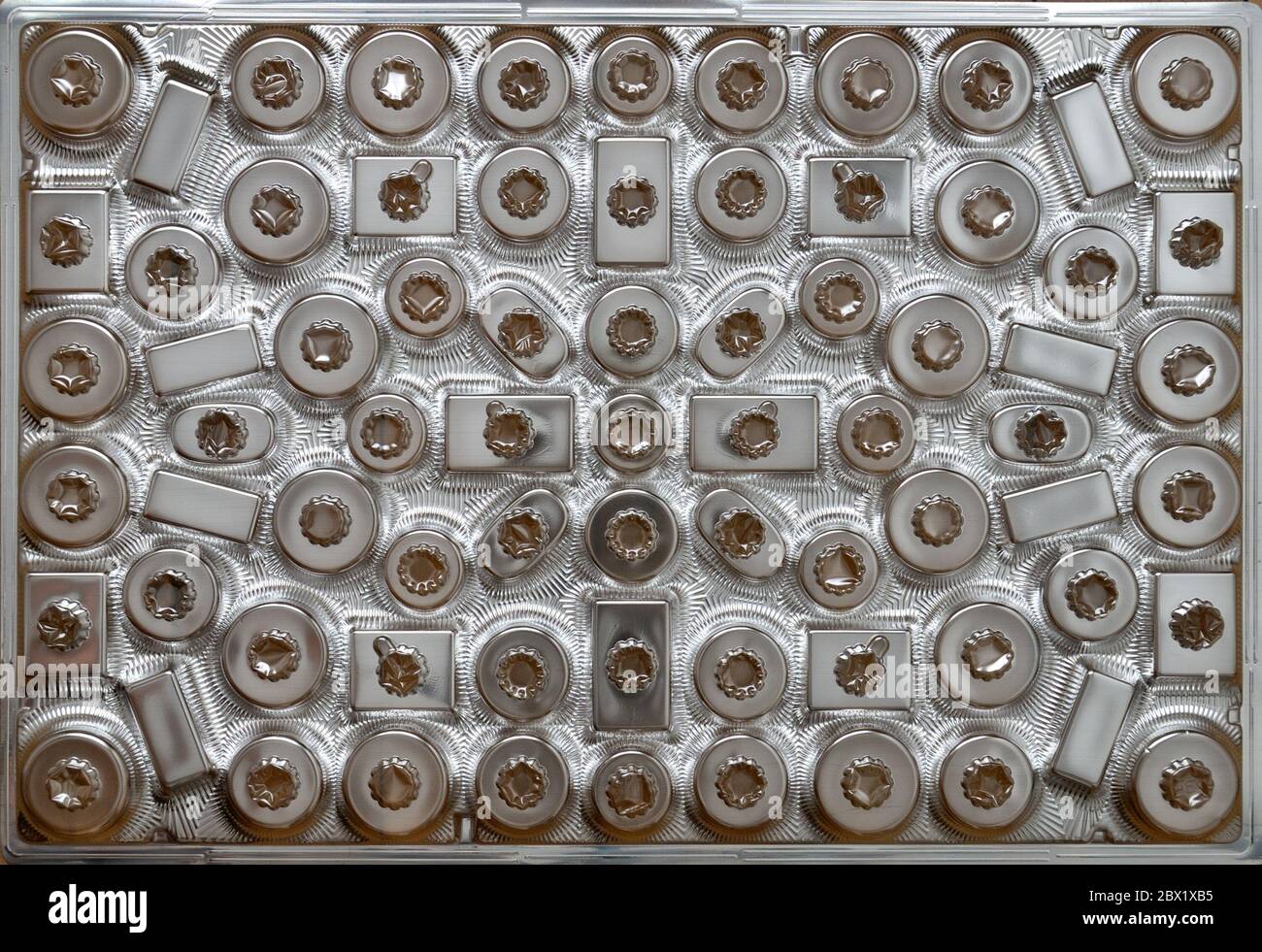 Back of chocolate box gift, shiny silver plastic background with small ...