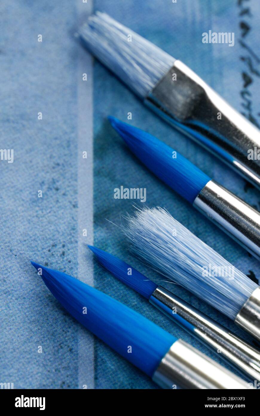 Ancient way of writing. Assortment of blue paintbrushes for calligraphy ...