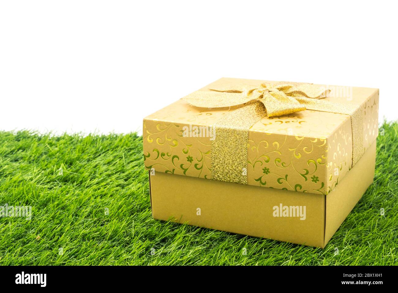 The Gift box on the green grass ground Stock Photo - Alamy