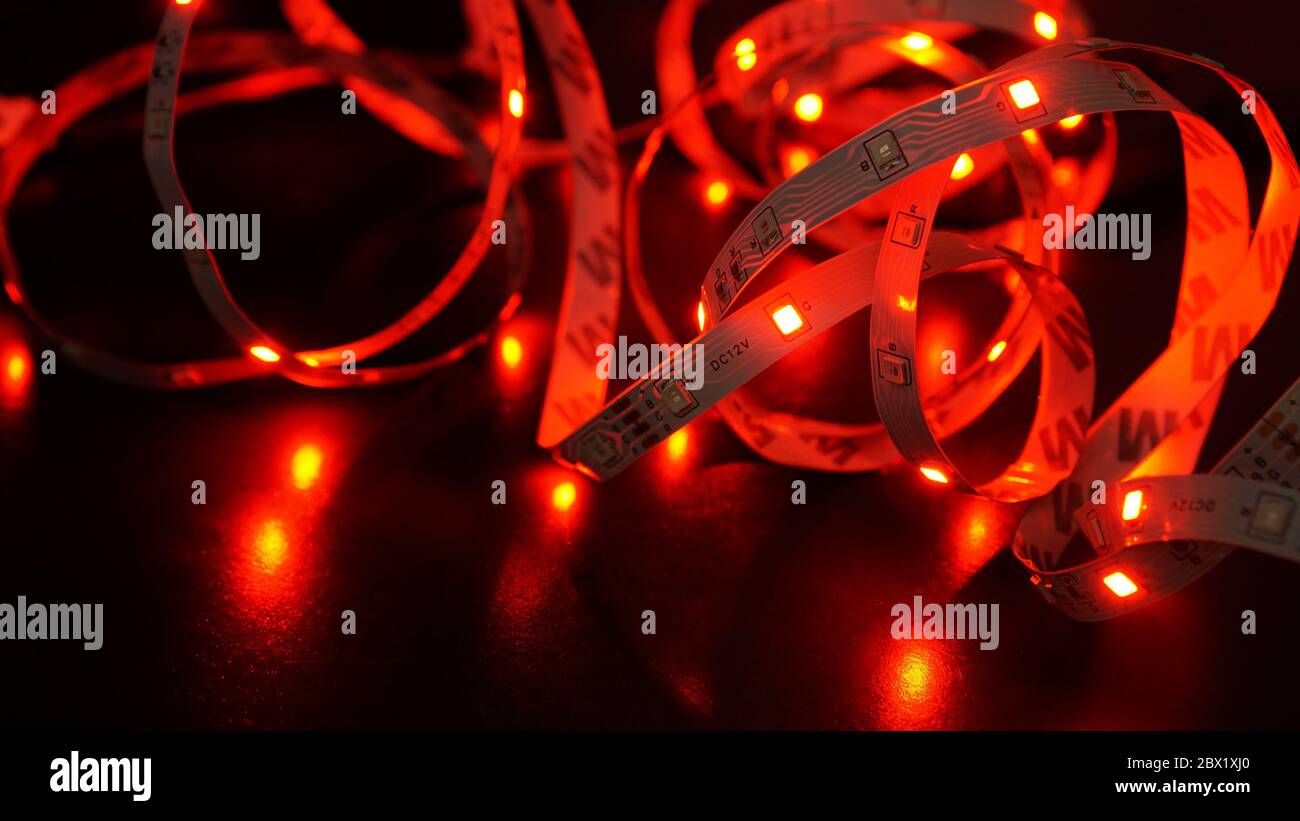 Red led illumination. Neon LED strip on a black background Stock Photo ...