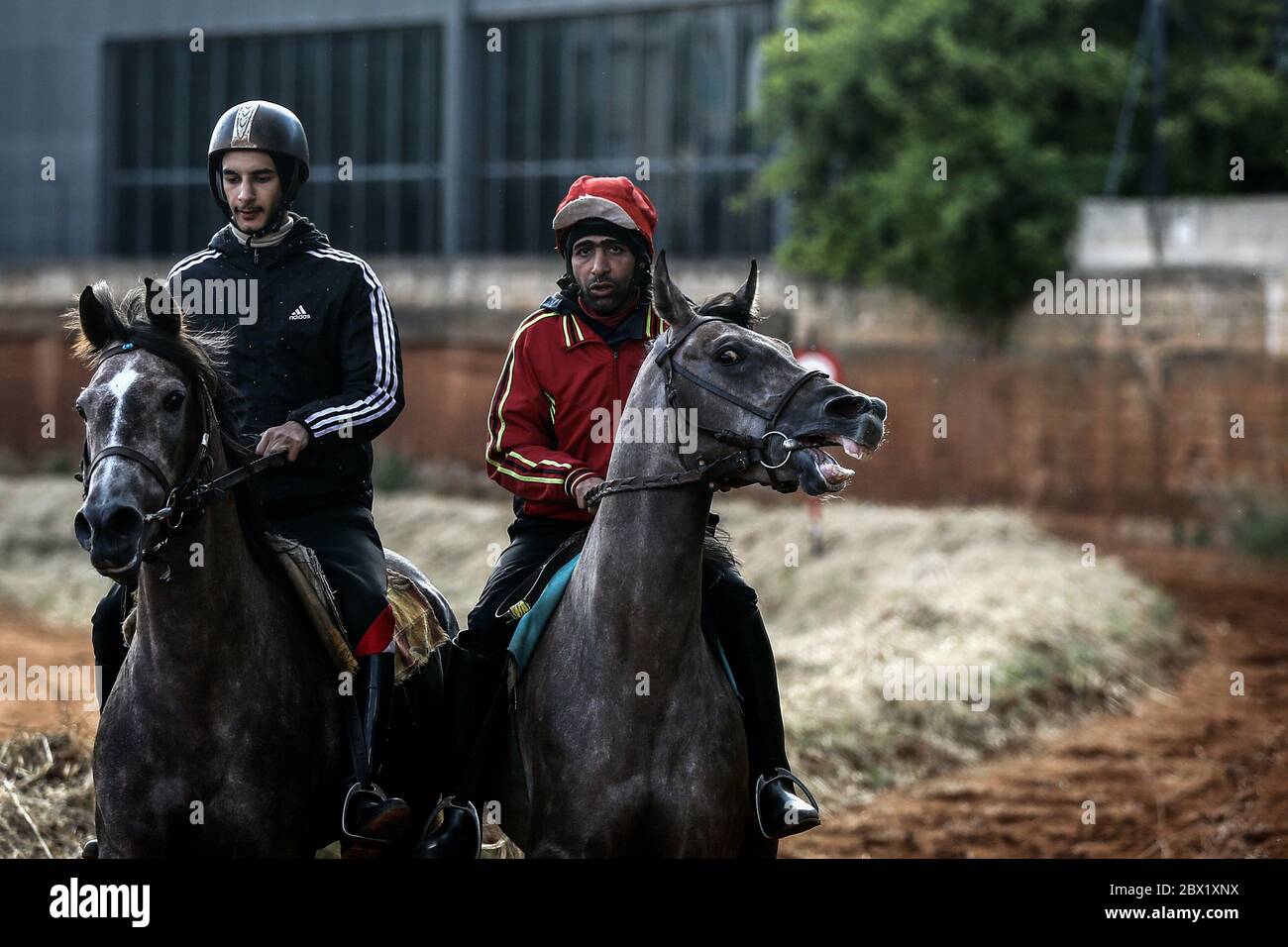 Beirut, Lebanon. 03rd June, 2020. Two jockeys ride their horses during ...