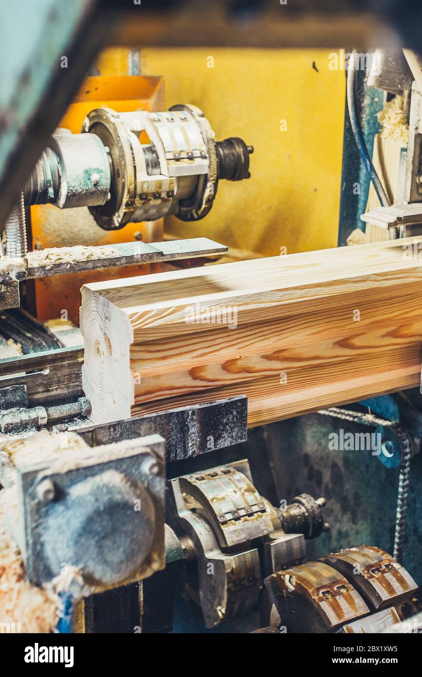 Cutting wooden log cups - production of profiled timber Stock Photo - Alamy