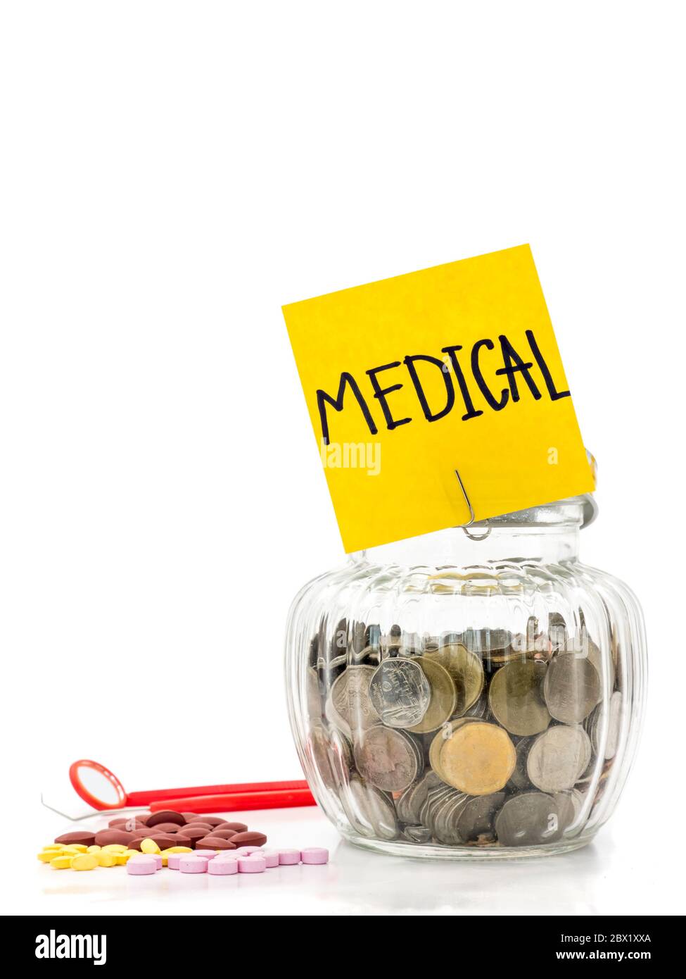 Coins in glass bottle with medicine on white background, saving money ...