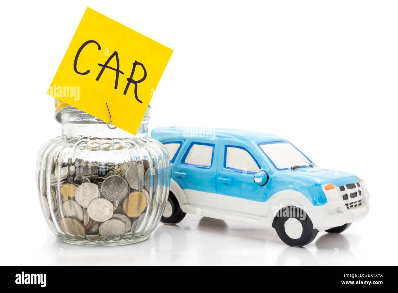 Coins in glass bottle on white background, saving money for Car Stock ...