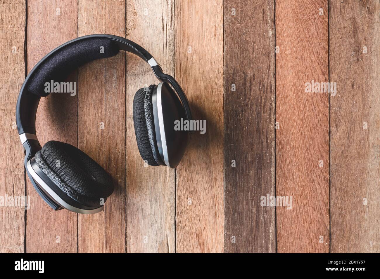 Top view of Headphones on wooden table background. Free space for text ...