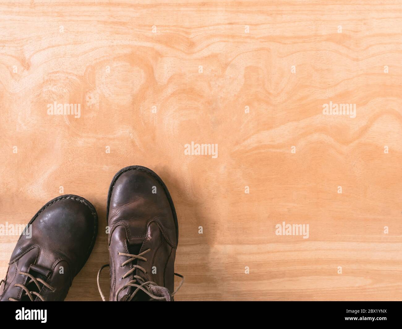Brown leather men's boots on wooden table background, free space for ...
