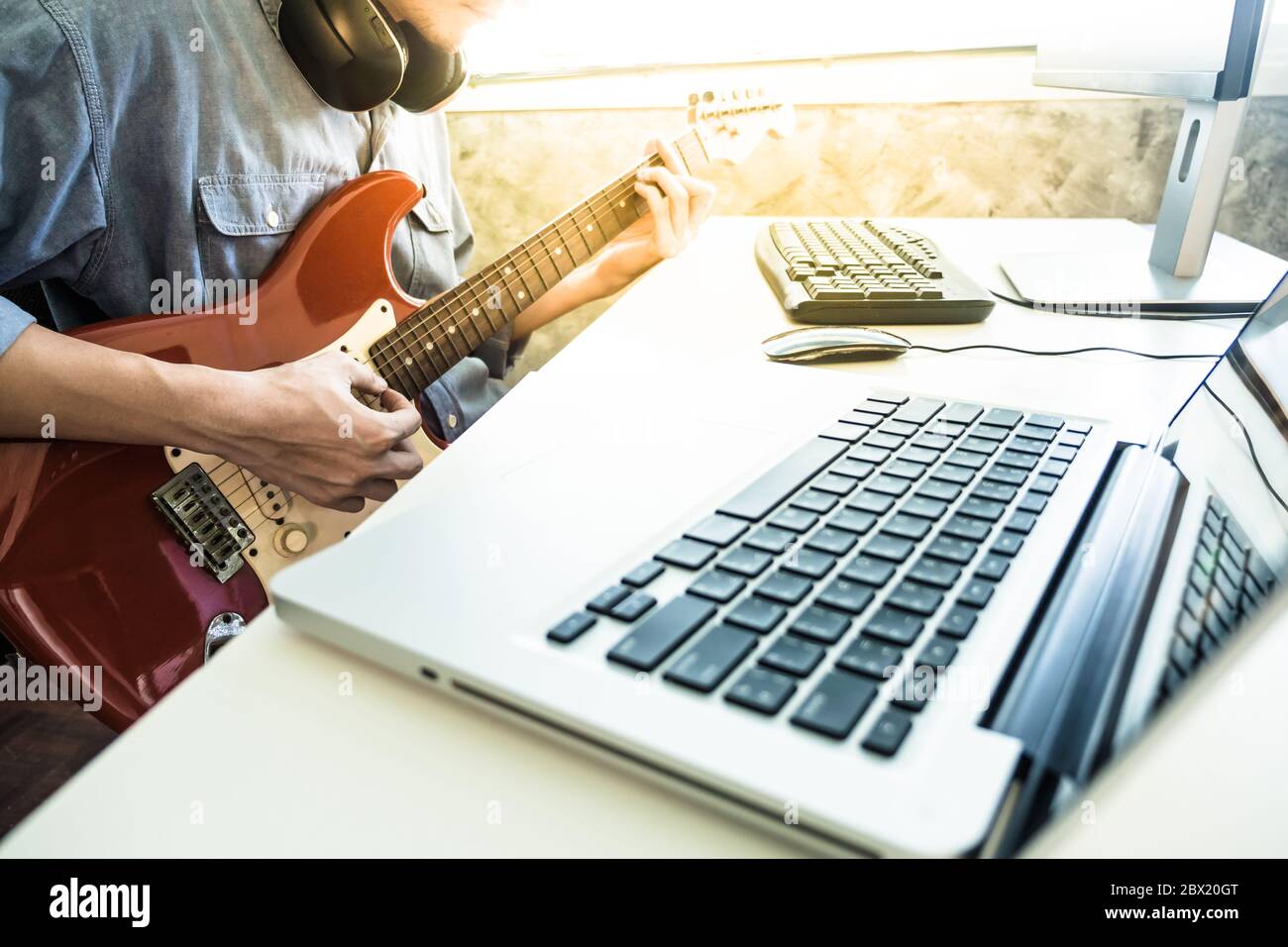 Professional musician recording electric guitar in digital studio at ...