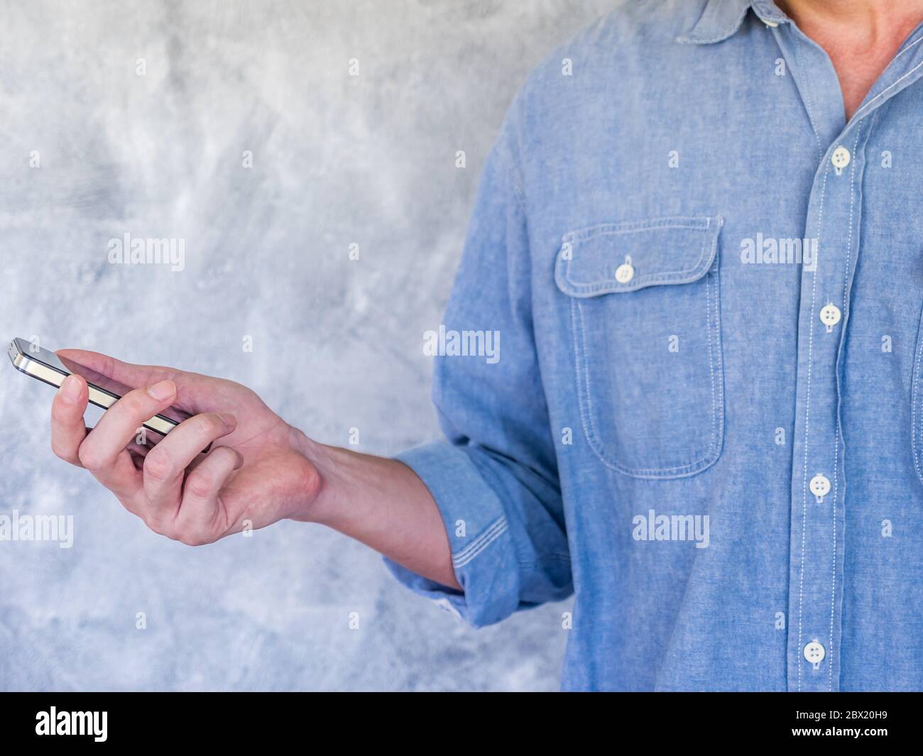 Close up of Casual man using smart phone on grunge background Stock ...