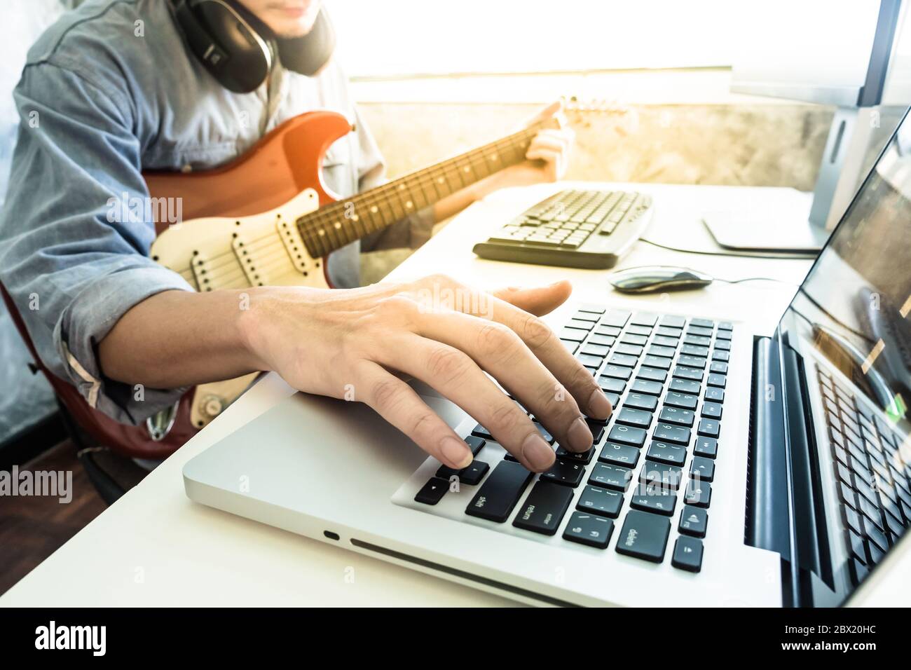 Professional musician recording electric guitar in digital studio at ...