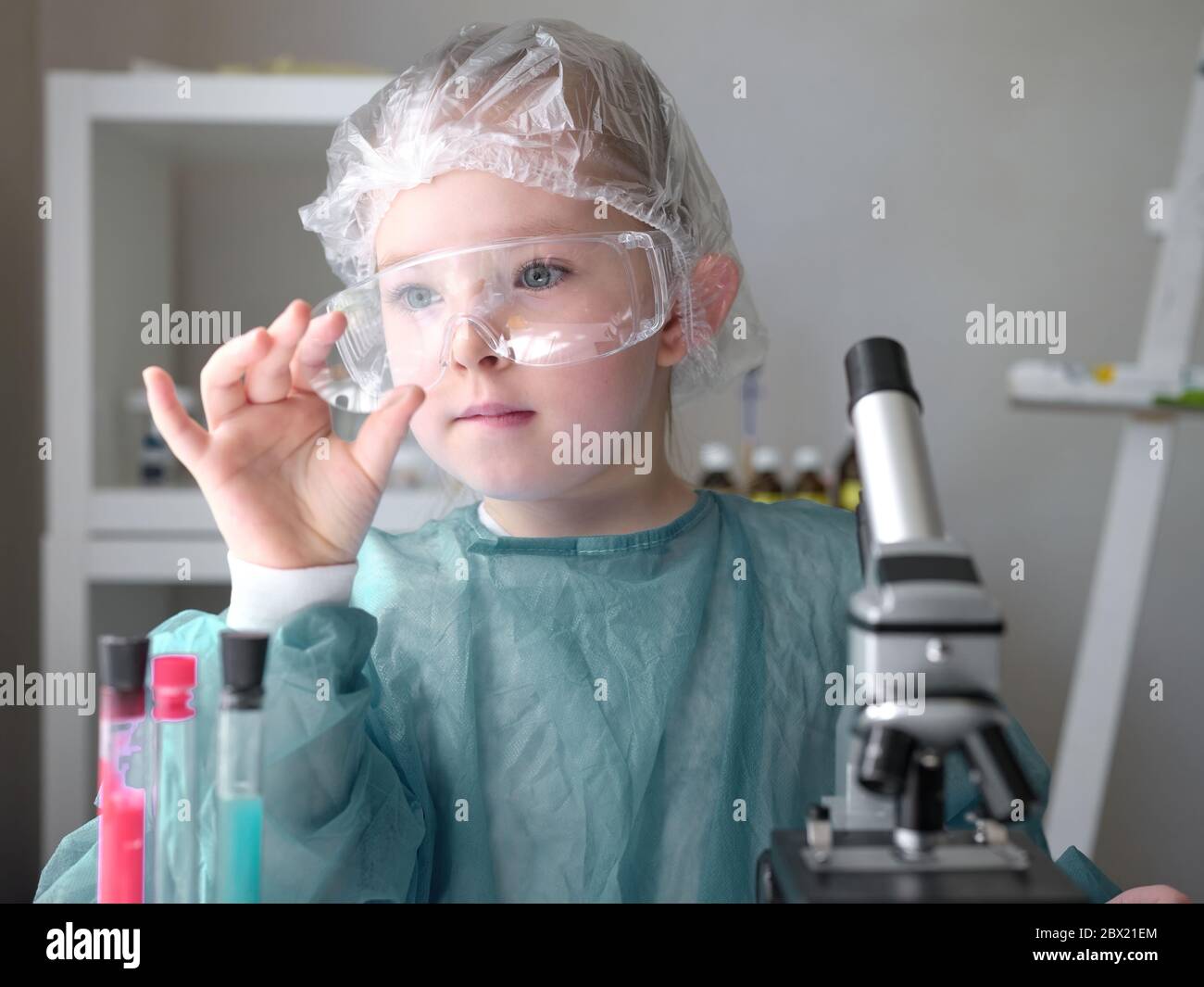 A little girl does scientific work in her home laboratory. The concept ...