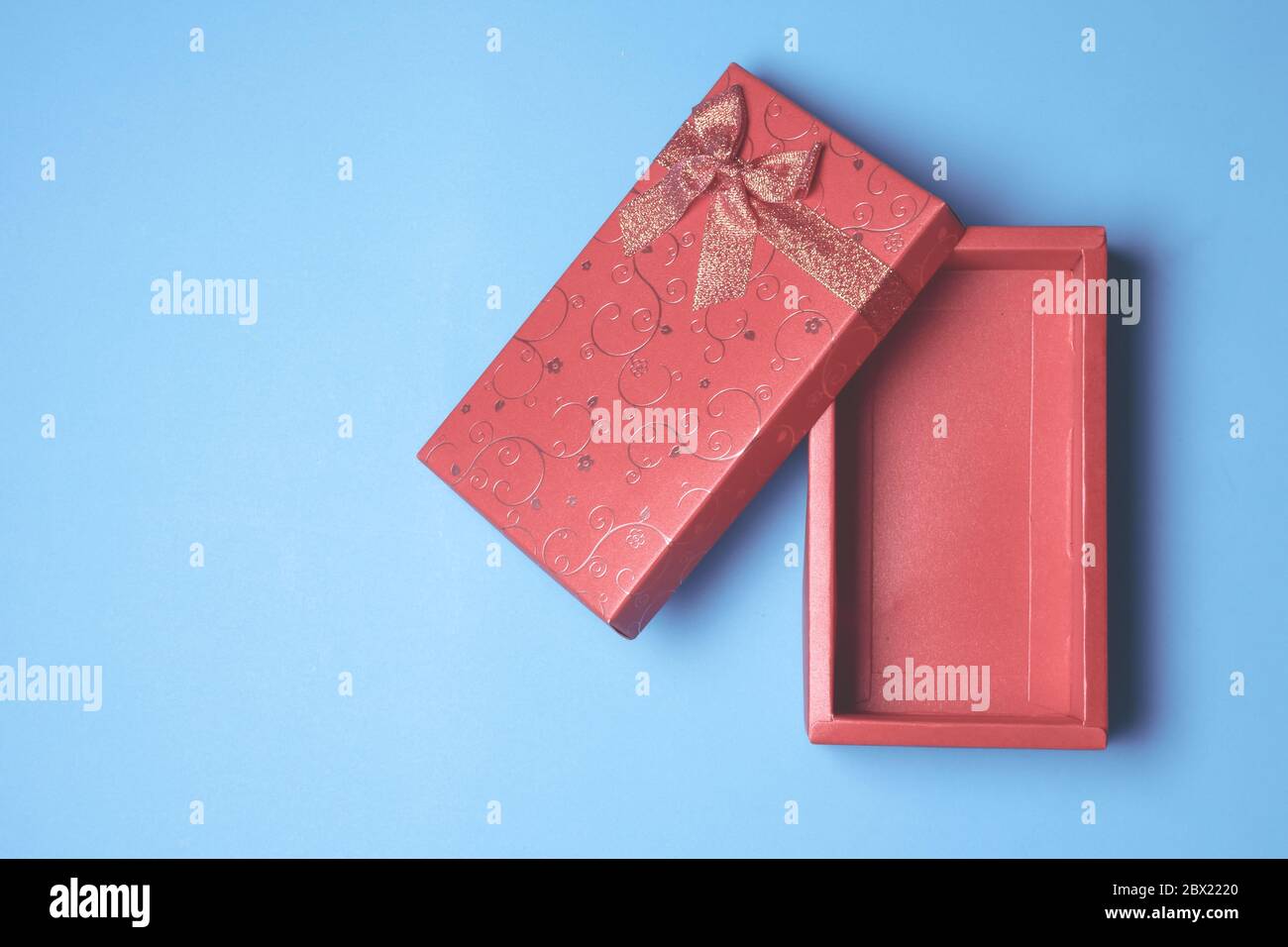 Top view of open red gift box on blue background. Free space for text ...