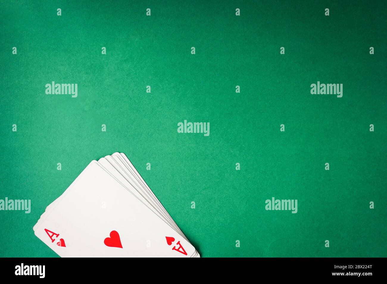 Playing cards on green background. Free space for text Stock Photo - Alamy