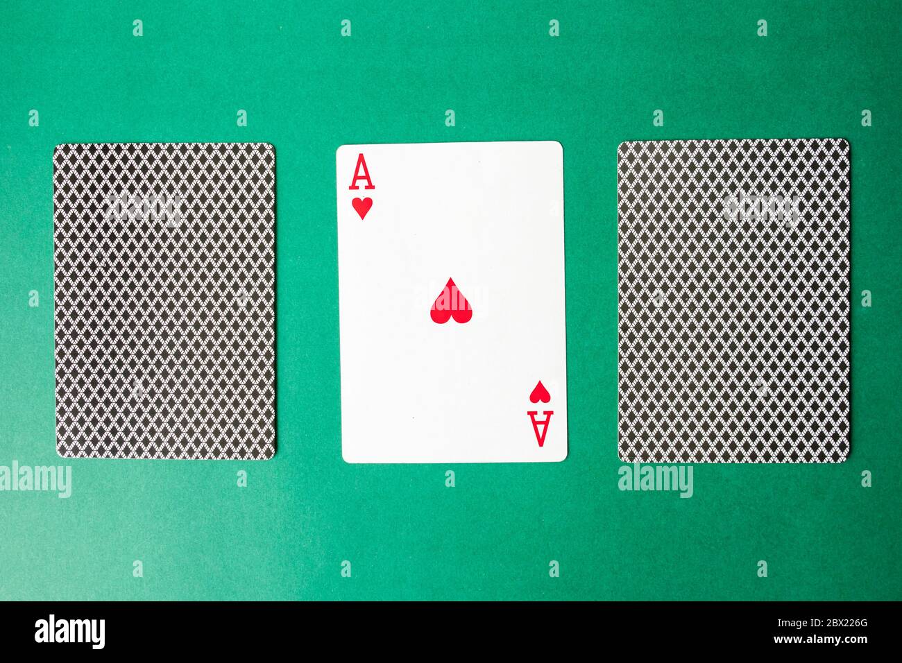 Playing card and back designs on green background. Free space for text ...