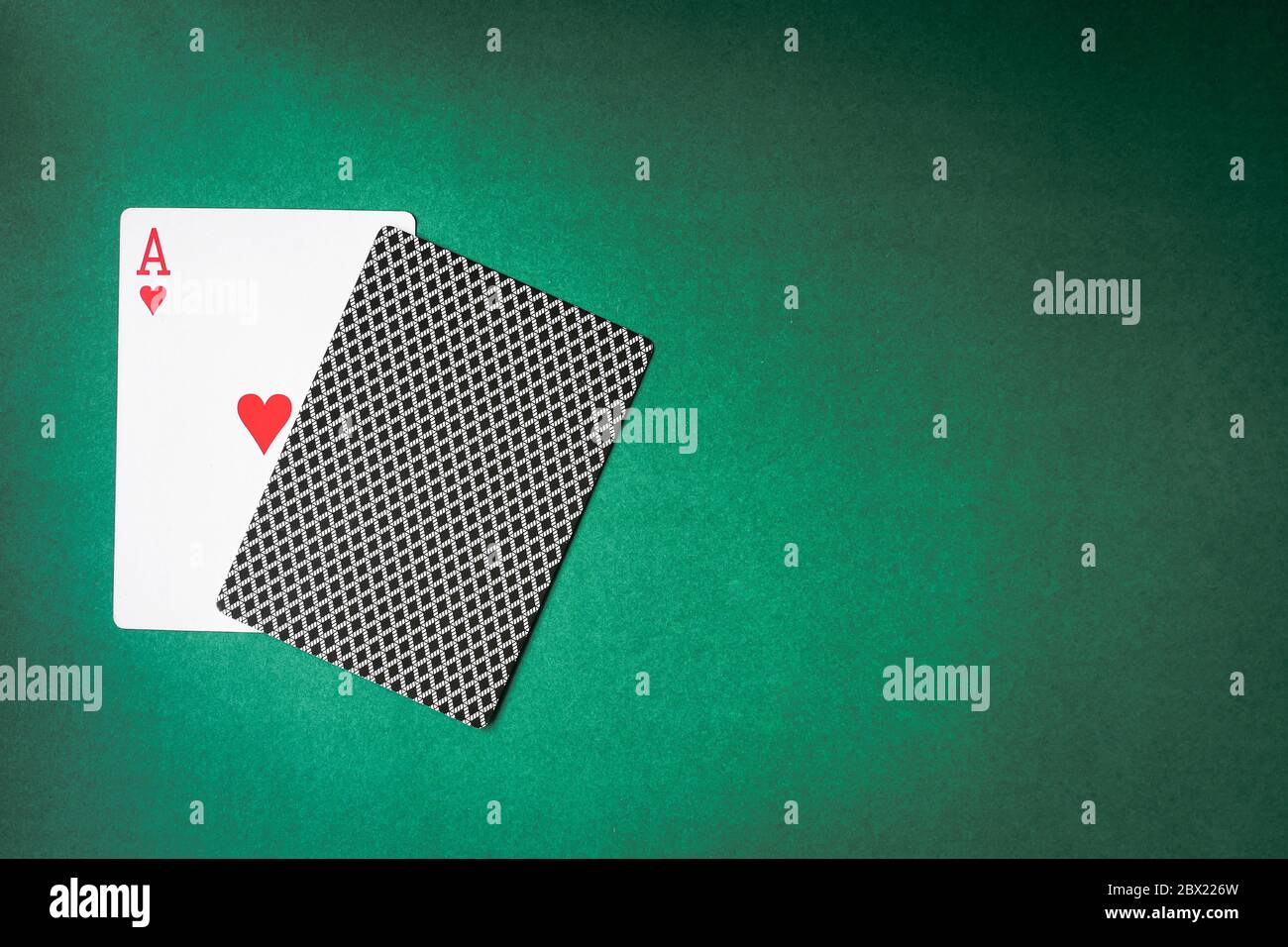 Playing card and back designs on green background. Free space for text ...