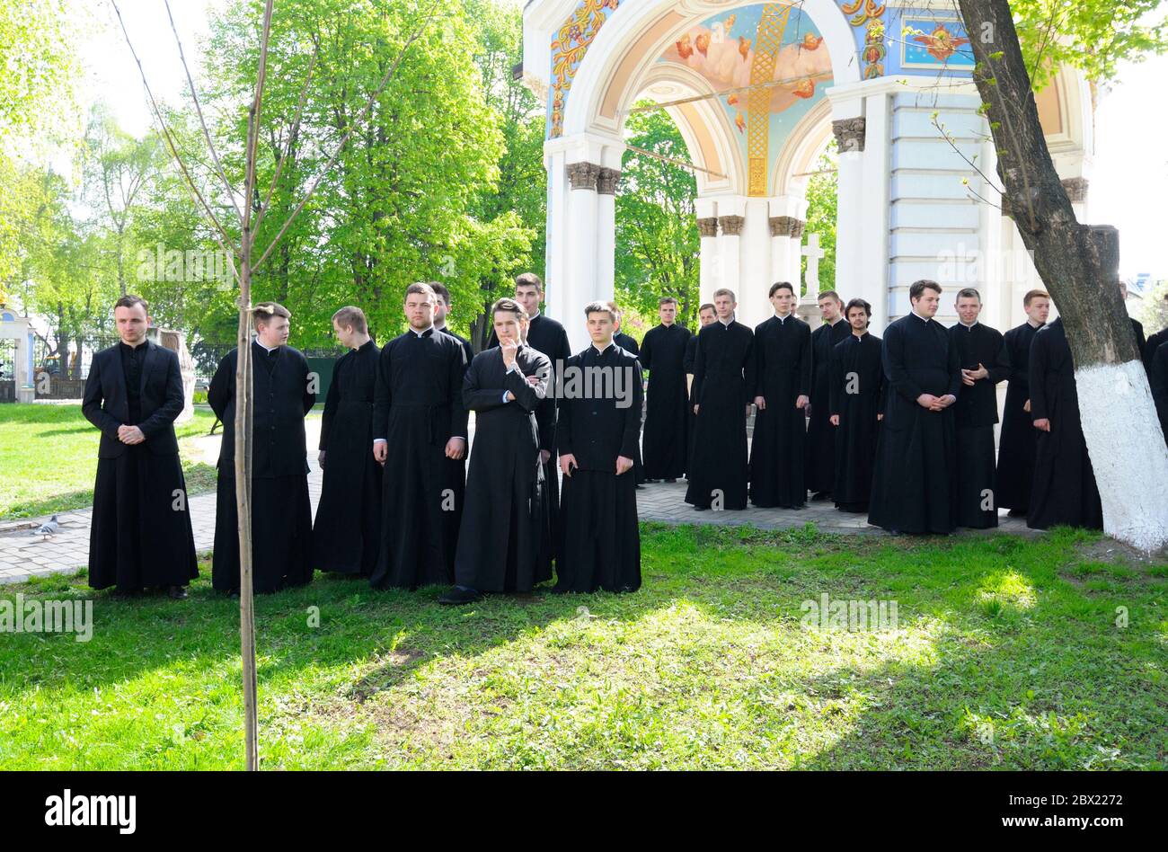 On the walk. Group of monks standing at the church backyard of the St ...
