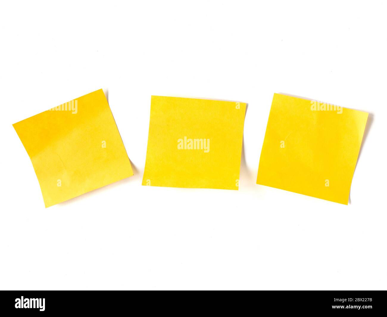 Yellow stick notes paper on white background Stock Photo - Alamy