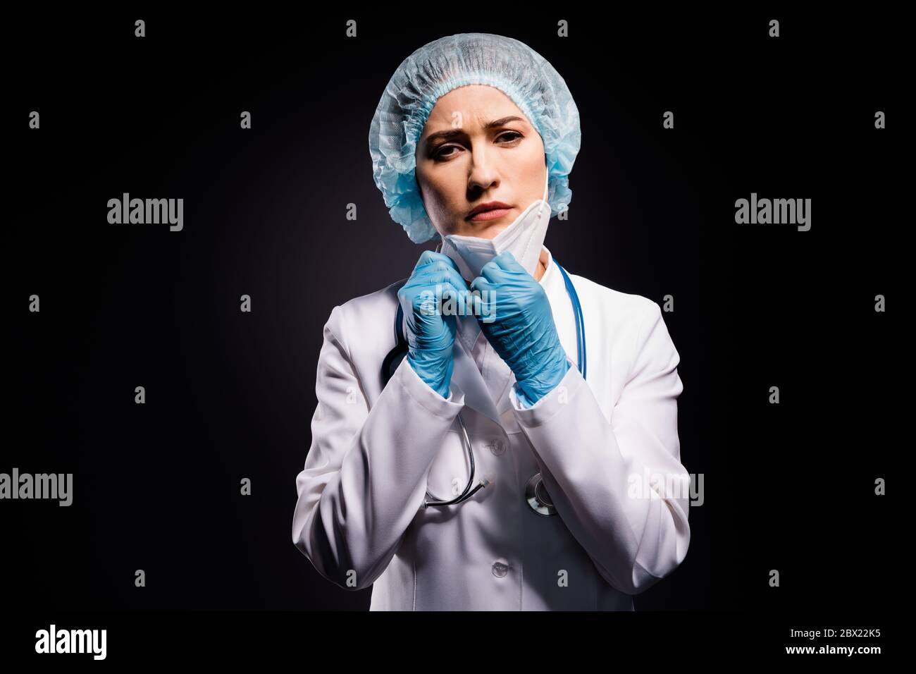 Photo of tired exhausted lady doc hold arms taking off protective mask ...