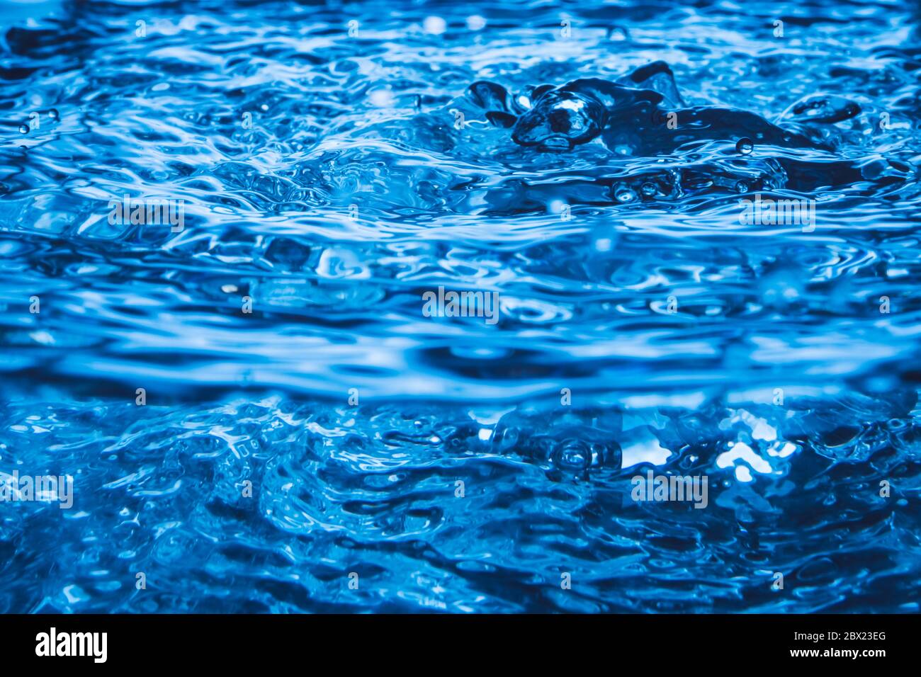 Blue wave and bubbles on water surface background Stock Photo - Alamy
